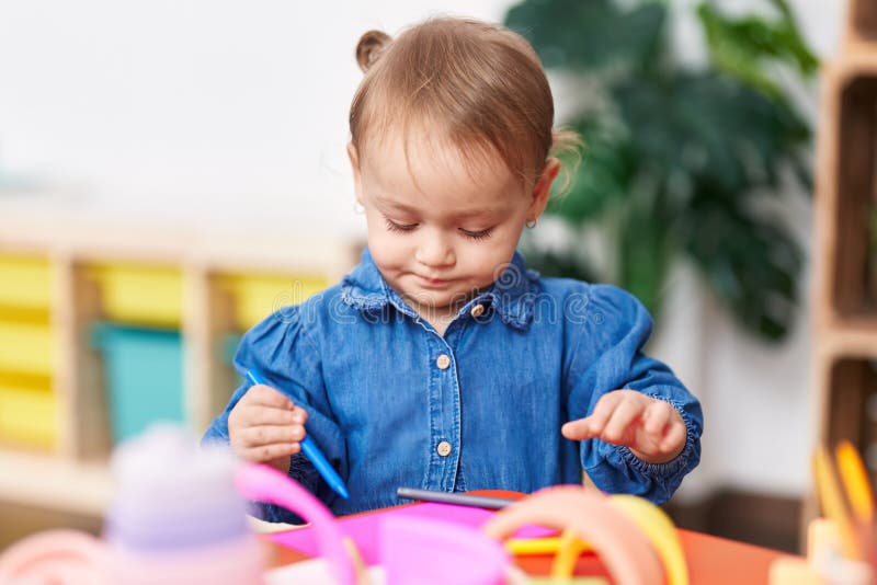 Adorable Hispanic Girl Student Drawing on Paper at Kindergarten Stock ...