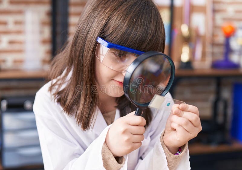 Adorable Hispanic Girl Student Looking Sample Using Magnifying Glass at ...