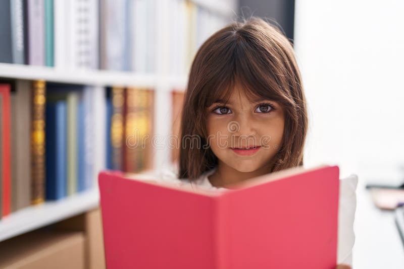 Adorable Hispanic Girl Student Smiling Confident Reading Book at ...