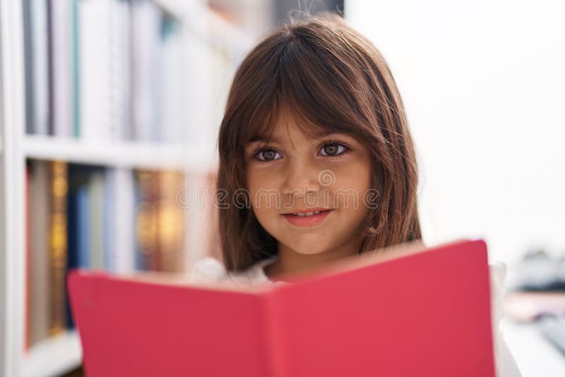 Adorable Hispanic Girl Student Smiling Confident Reading Book at ...