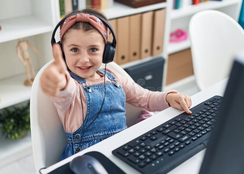 Adorable Hispanic Girl Student Using Computer Doing Thumb Up Gesture at ...