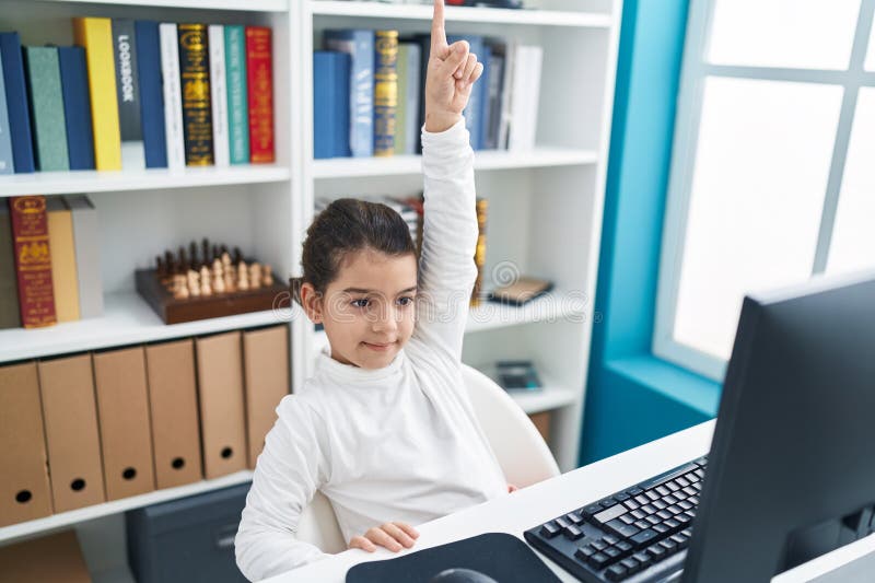 Adorable Hispanic Girl Student Using Computer with Finger Raised Up at ...