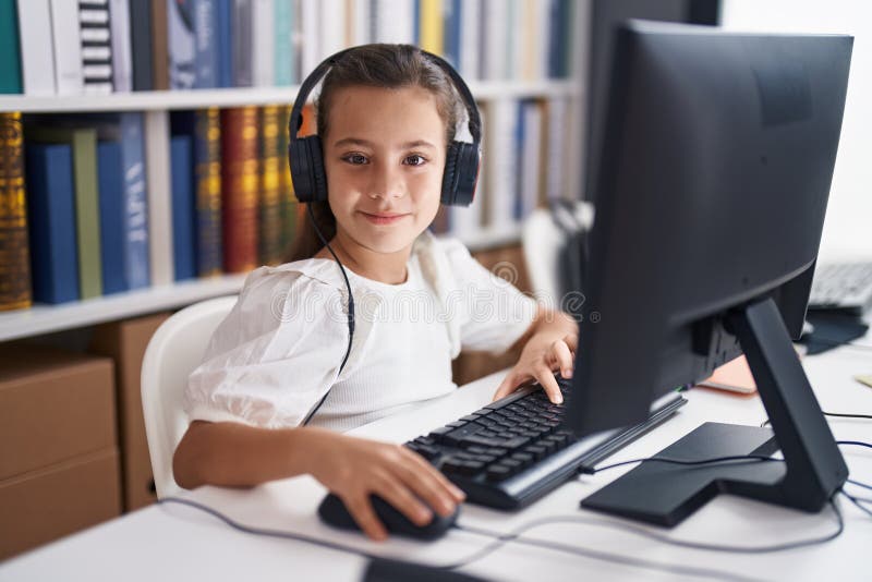 Adorable Hispanic Girl Student Using Computer and Headphones Sitting on ...