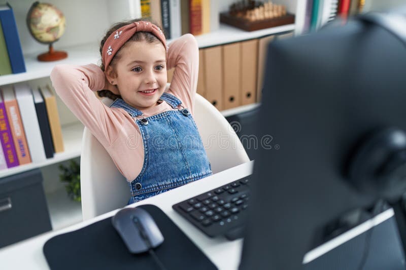 Adorable Hispanic Girl Student Using Computer Relaxed with Hands on ...