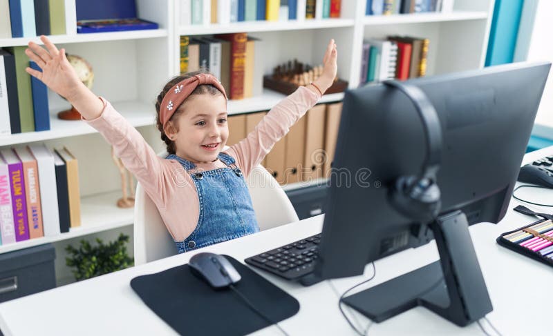 Adorable Hispanic Girl Student Using Computer with Winner Expression at ...