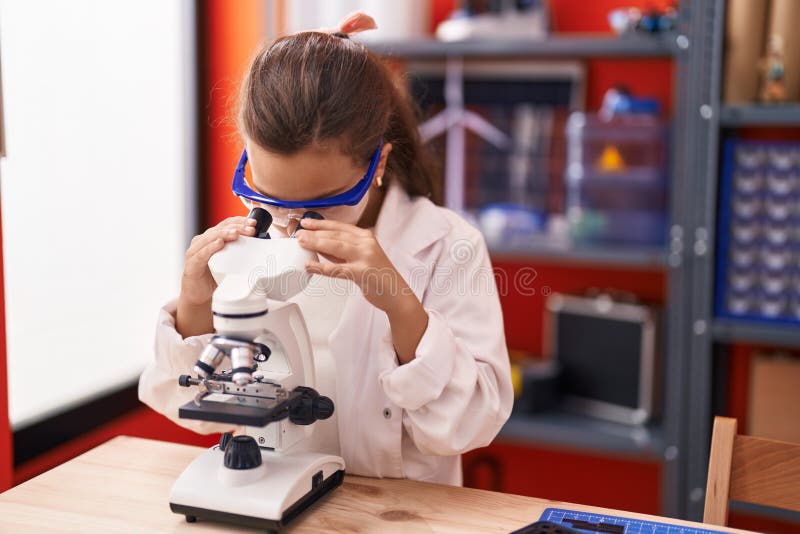 Adorable Hispanic Girl Student Using Microscope at Classroom Stock ...