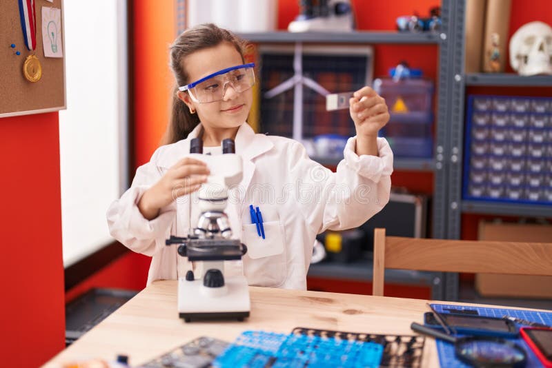Adorable Hispanic Girl Student Using Microscope Looking Sample at ...