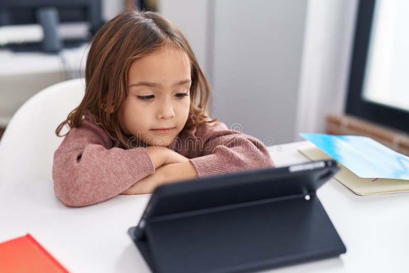 Adorable Hispanic Girl Student Using Touchpad Sitting on Table at ...