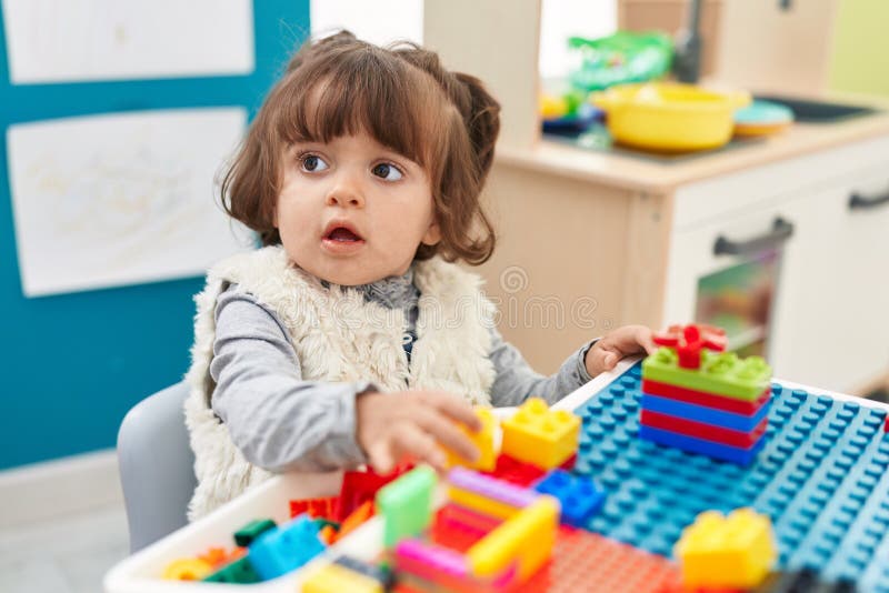Adorable Hispanic Toddler Playing with Construction Blocks Sitting on ...