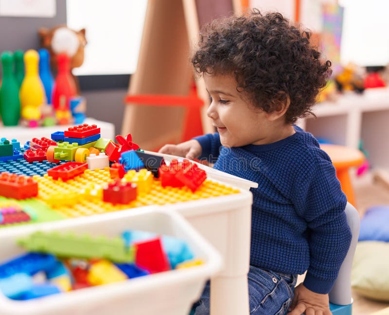 Adorable Hispanic Toddler Playing with Construction Blocks Sitting on ...