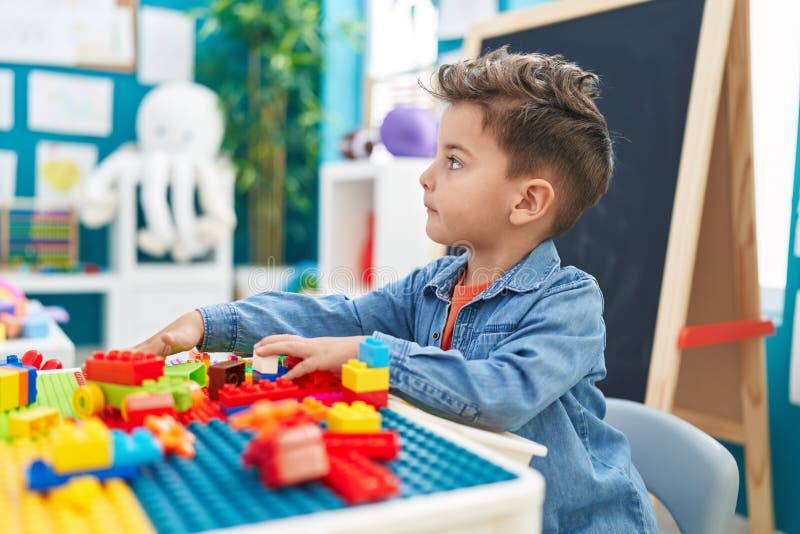 Adorable Hispanic Toddler Playing with Construction Blocks Sitting on ...