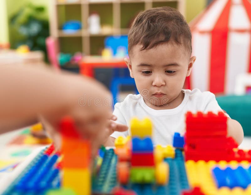 Adorable Hispanic Toddler Playing with Construction Blocks Sitting on ...
