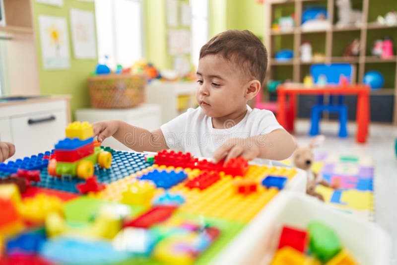 Adorable Hispanic Toddler Playing with Construction Blocks Sitting on ...