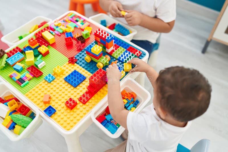Adorable Hispanic Toddler Playing with Construction Blocks Sitting on ...