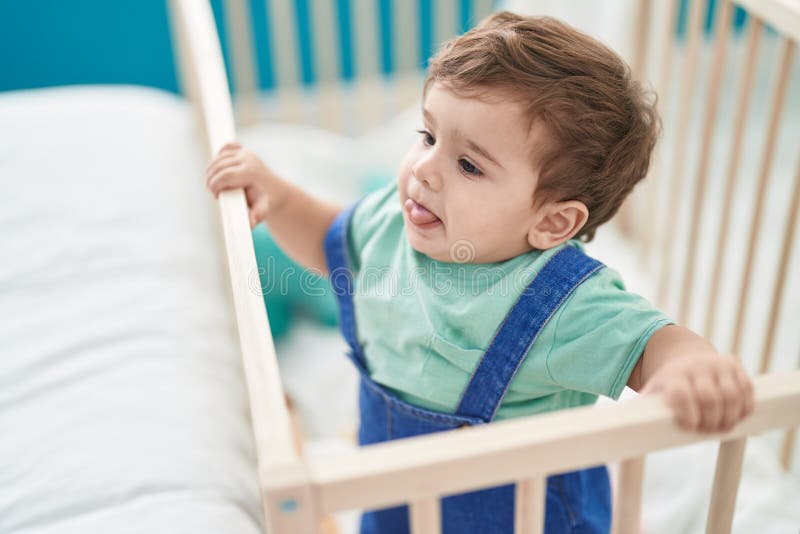 Adorable Hispanic Toddler Standing on Cradle at Bedroom Stock Photo ...