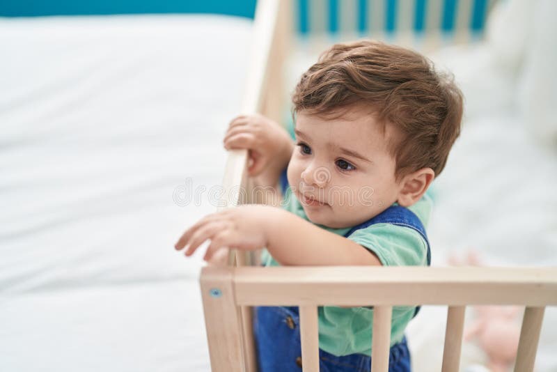 Adorable Hispanic Toddler Standing on Cradle at Bedroom Stock Photo ...