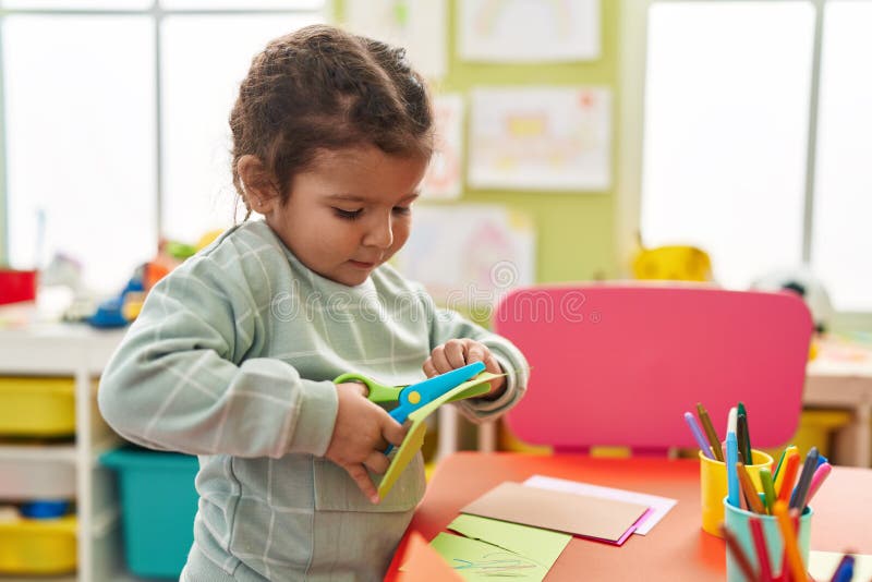 Adorable Hispanic Toddler Student Cutting Paper at Kindergarten Stock ...