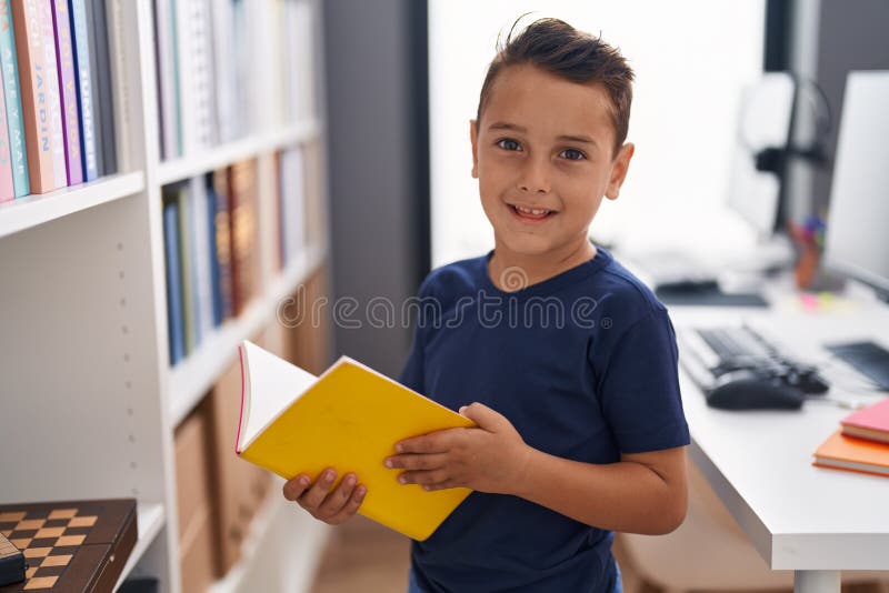 Adorable Hispanic Toddler Student Reading Book Standing at Library ...