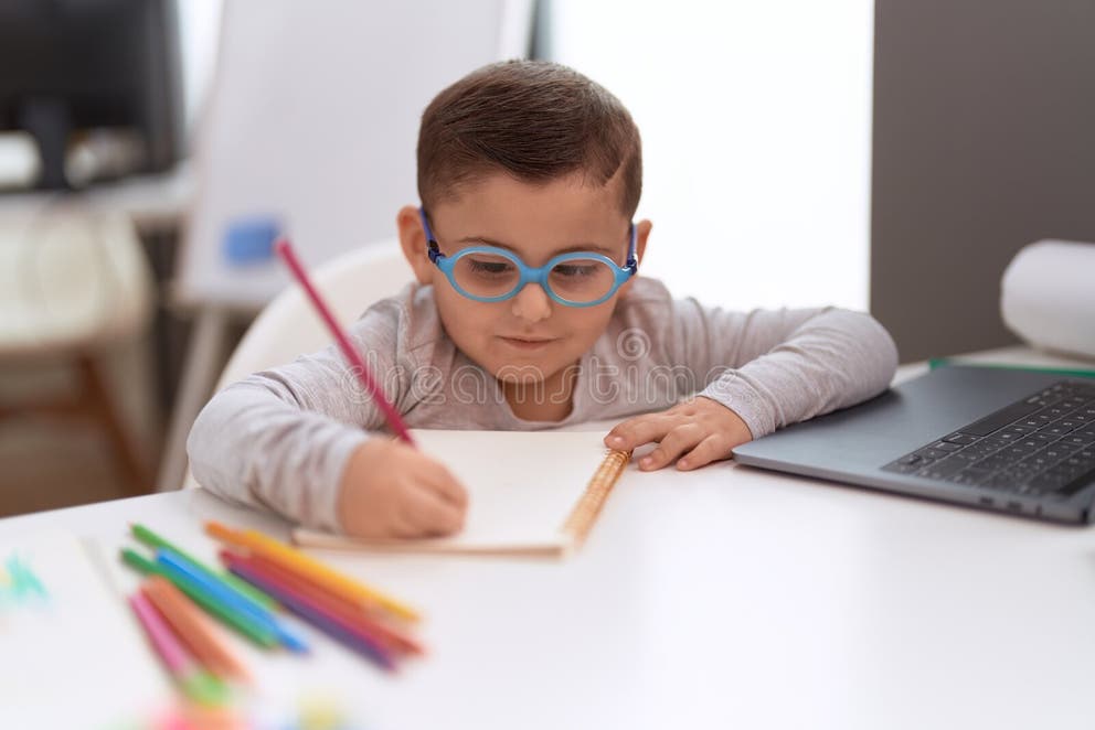 Adorable Hispanic Toddler Student Using Laptop Drawing on Notebook at ...