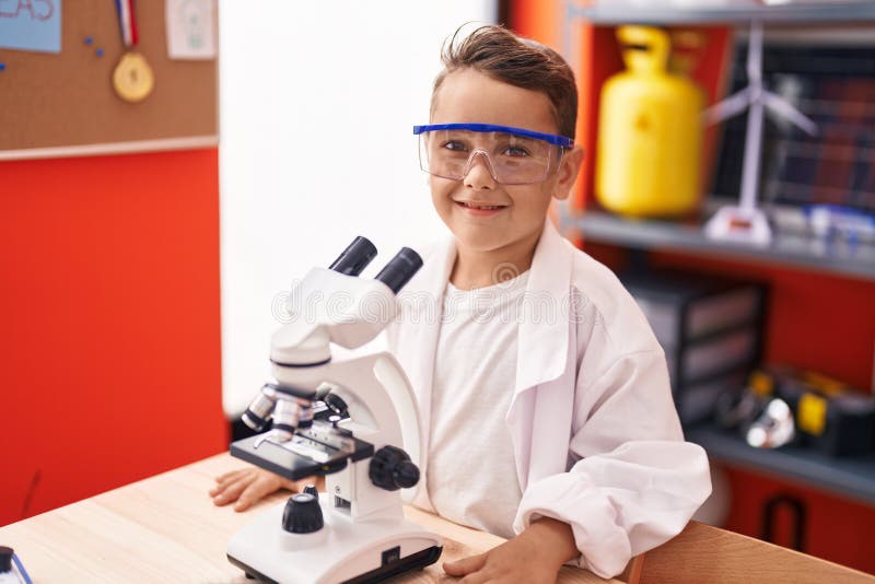 Adorable Hispanic Toddler Student Using Microscope Standing at ...