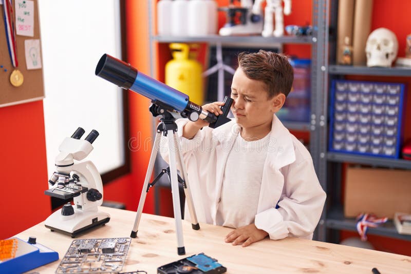 Adorable Hispanic Toddler Student Using Telescope at Classroom Stock ...