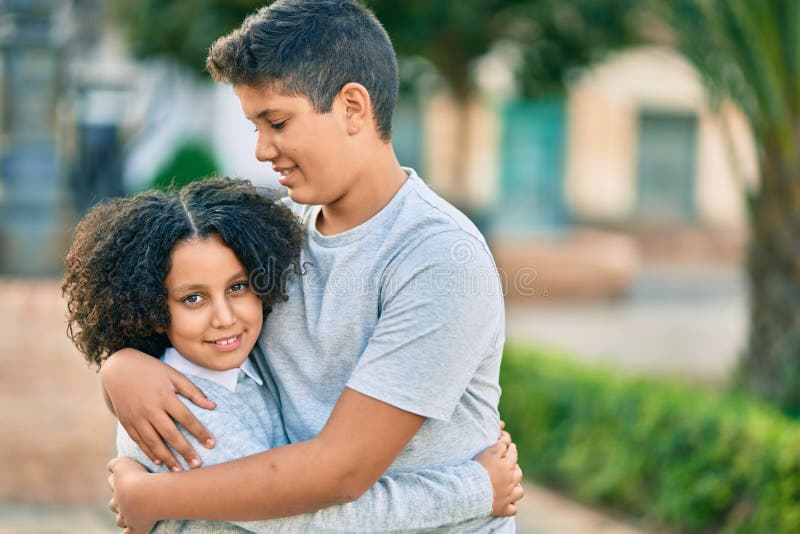 Adorable Latin Brother and Sister Hugging at the Park Stock Photo ...