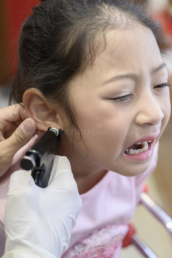 Adorable Little Asian Girl Having Ear Piercing Process. Stock Image ...