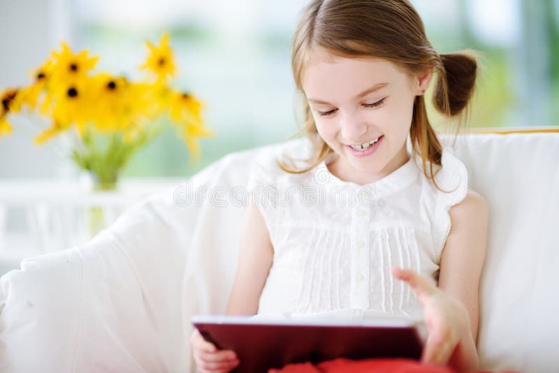 Adorable Little Girl Playing with a Digital Tablet Stock Image - Image ...