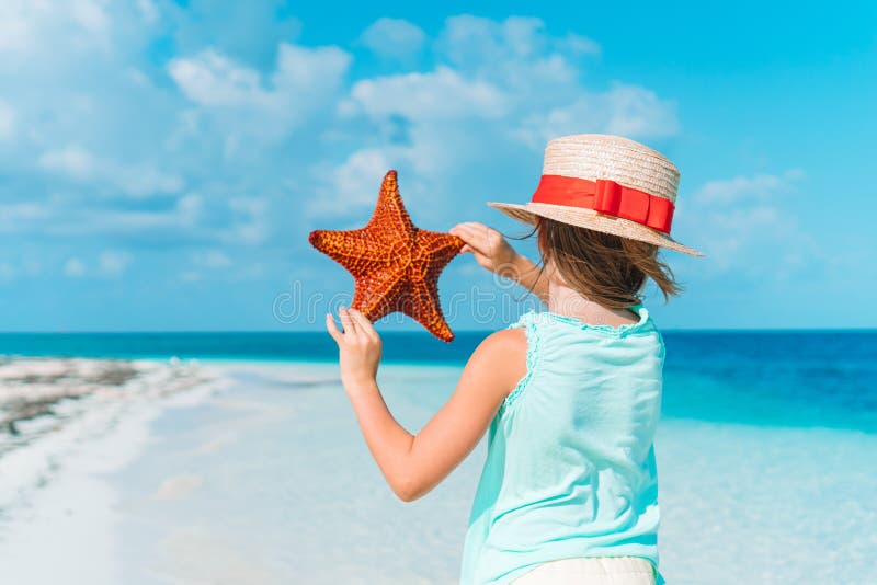 Adorable Little Girl with Starfish on White Empty Beach Stock Photo ...