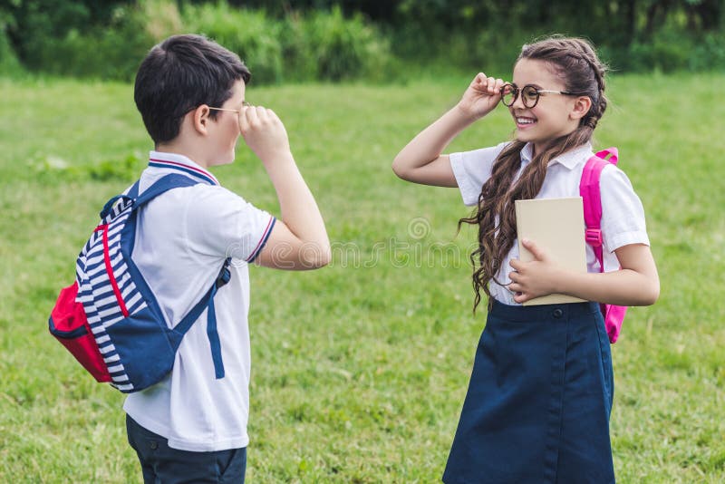 Adorable Schoolchildren with Backpacks Looking at Each Other Stock ...