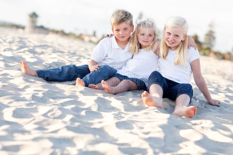 Adorable Sisters and Brother Having Fun at the Bea Stock Photo - Image ...