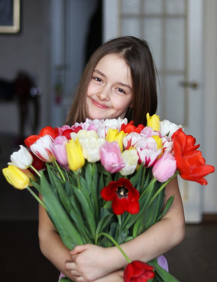 Adorable Smiling Little Girl Holding Big Bouquet of Tulips, Indoor ... Adorable Smiling Little Girl Holding Big Bouquet of Tulips, Indoor ...