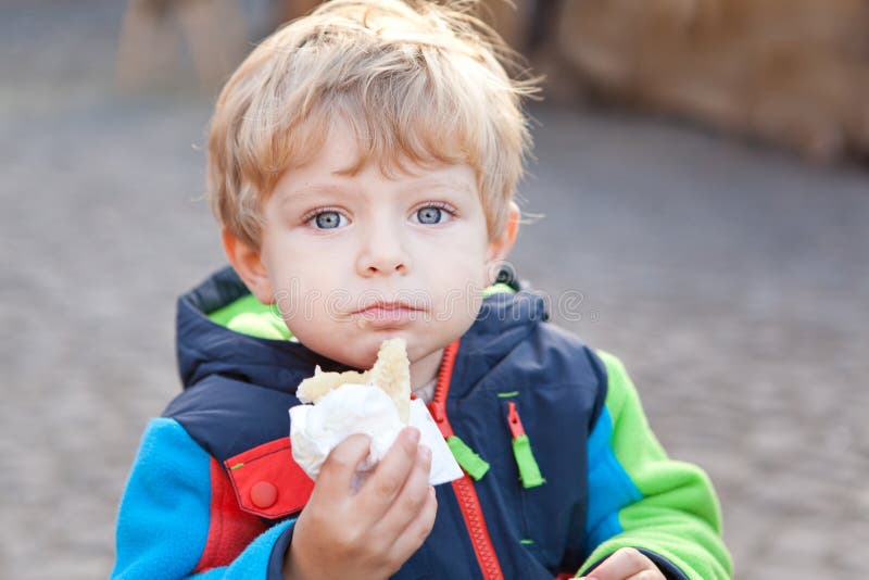 Adorable Toddler Eating Bread Outdoor Stock Photo - Image of happy ...
