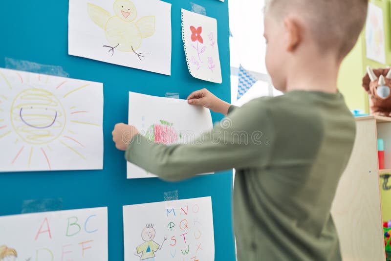 Adorable Toddler Hanging Draw on Wall at Classroom Stock Image - Image ...