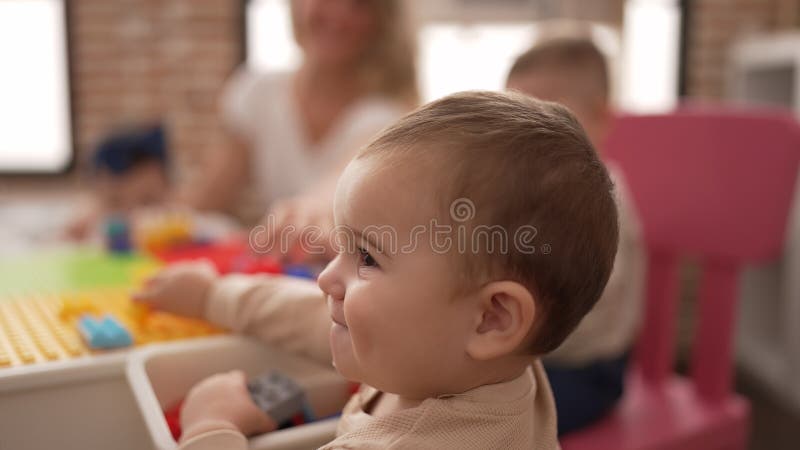 Adorable Toddler Holding Plastic Construction Blocks Sitting on Table ...