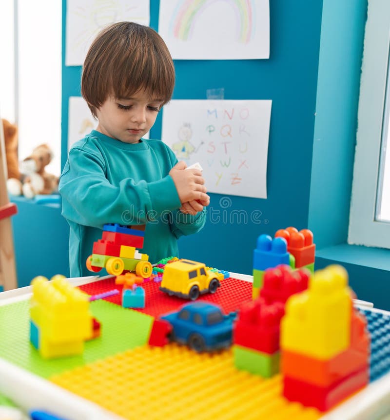 Adorable Toddler Playing with Construction Blocks Standing at ...