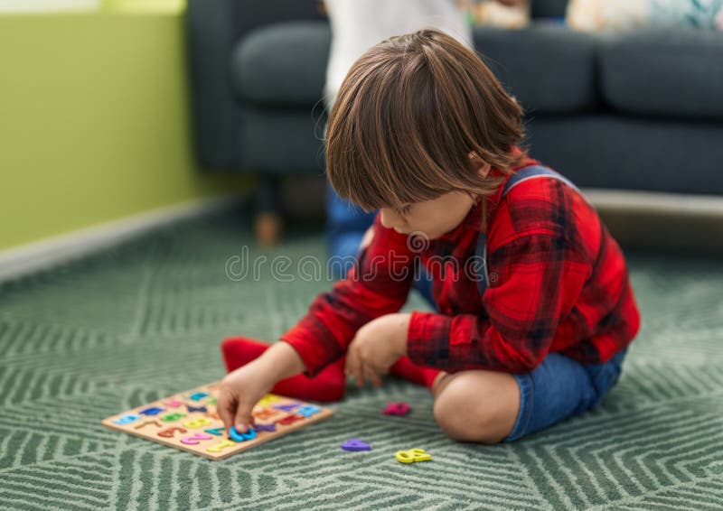Adorable Toddler Playing with Maths Game Sitting on Floor at Home Stock ...