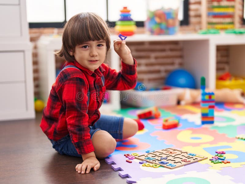 Adorable Toddler Playing with Maths Game Sitting on Floor at ...