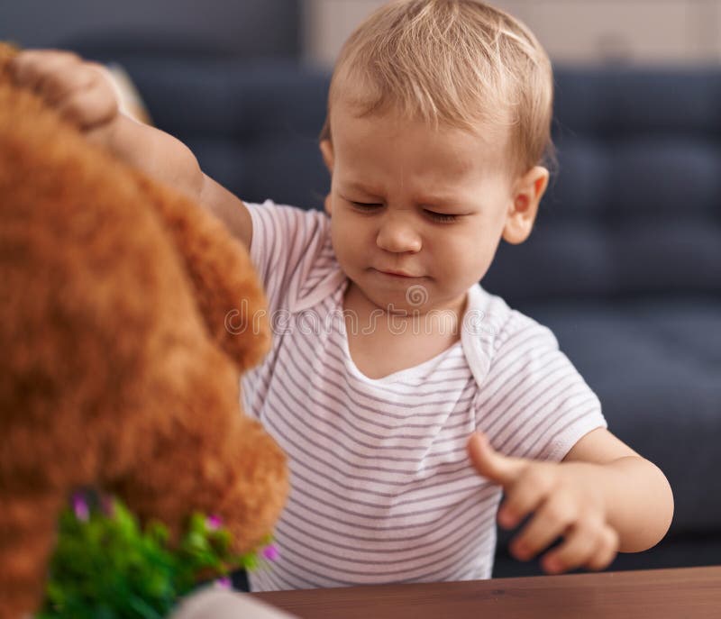 Adorable Toddler Playing with Teddy Bear and Crying at Home Stock Photo ...