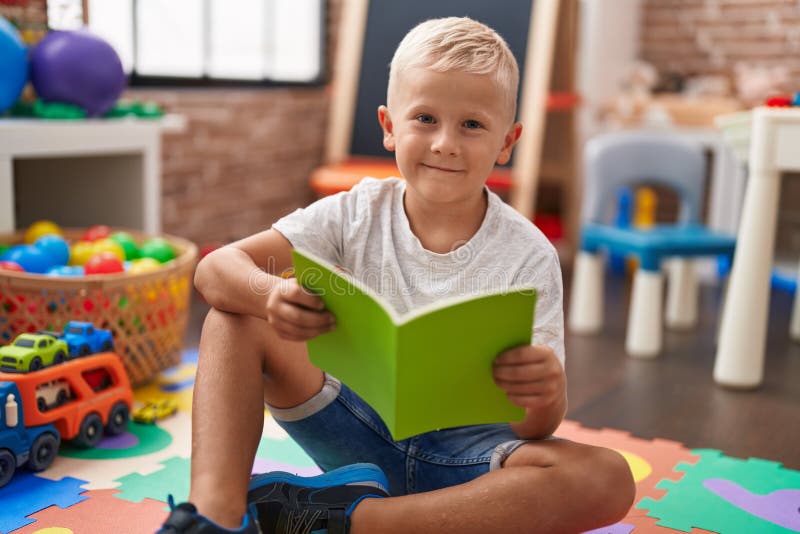 Adorable Toddler Reading Book Sitting on Floor at Classroom Stock Image ...