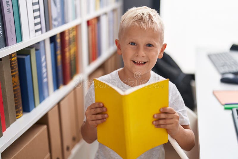 Adorable Toddler Reading Book Standing at Classroom Stock Photo - Image ...
