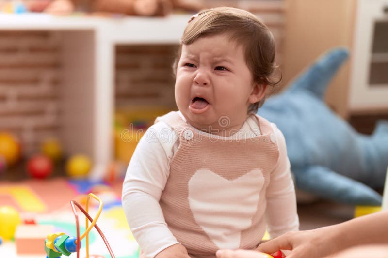 Adorable Toddler Sitting on Floor Crying at Kindergarten Stock Photo ...