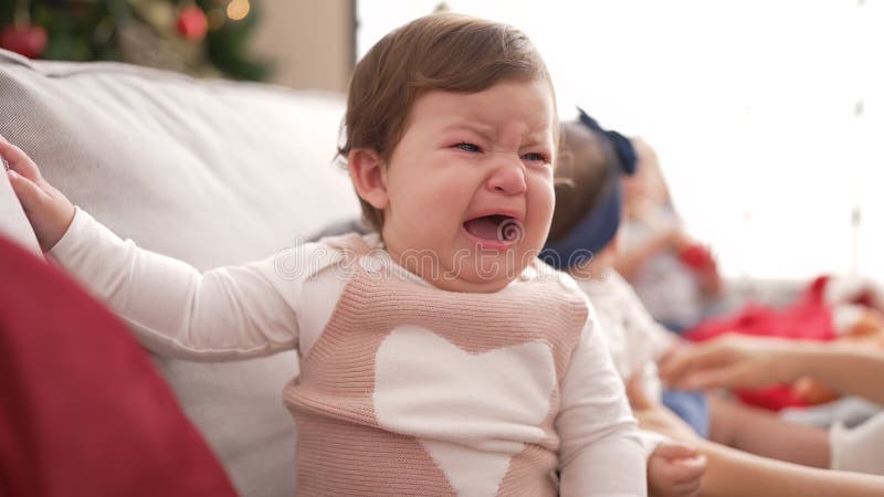 Adorable Toddler Sitting on Sofa by Christmas Tree Crying at Home Stock ...