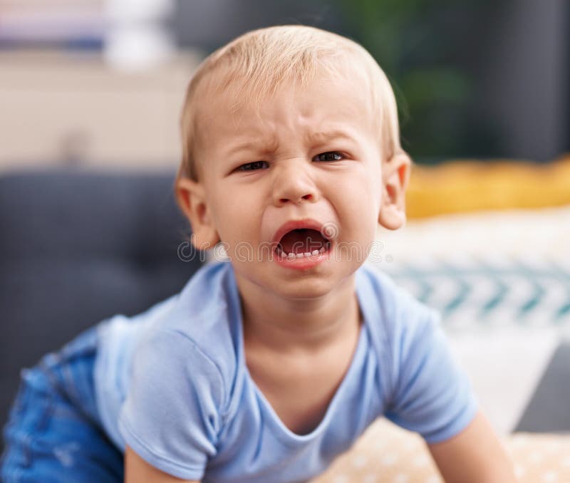 Adorable Toddler Sitting on Sofa Crying at Home Stock Photo - Image of ...