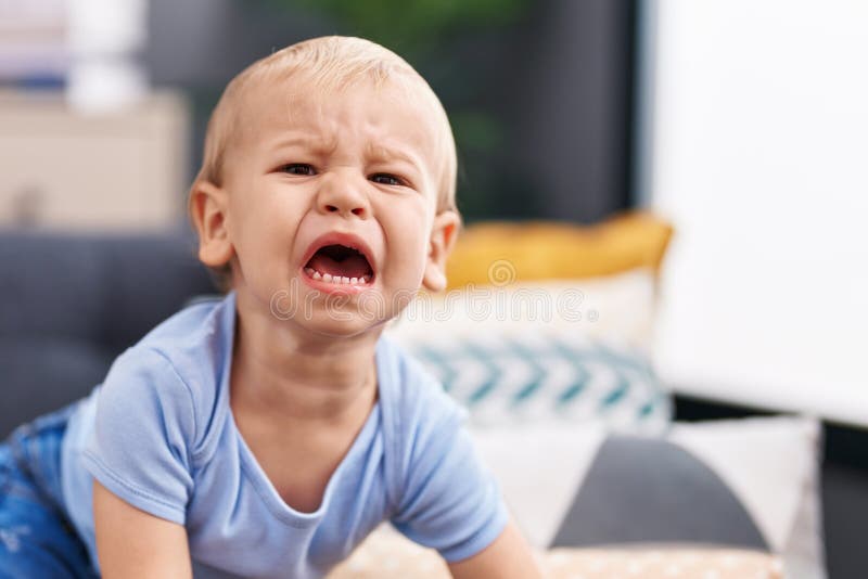 Adorable Toddler Sitting on Sofa Crying at Home Stock Photo - Image of ...