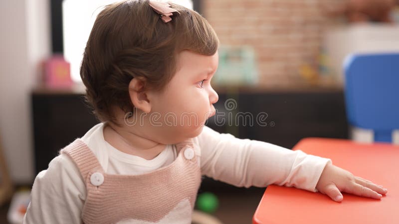 Adorable Toddler Standing with Relaxed Expression Leaning on Table at ...
