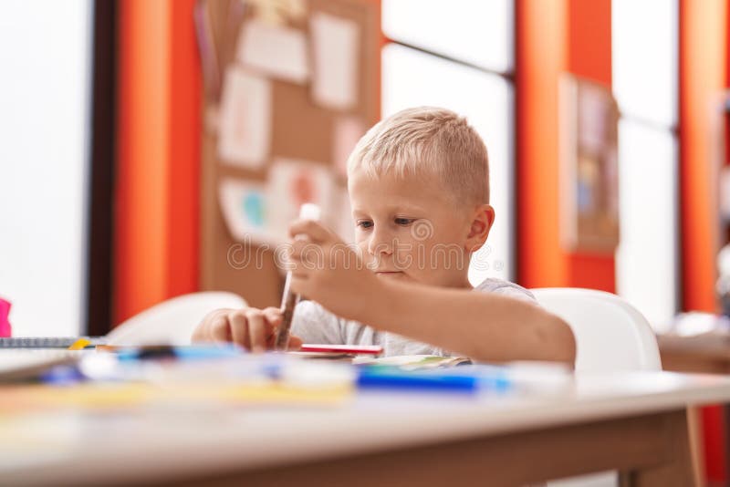 Adorable Toddler Student Drawing on Notebook Sitting on Table at ...