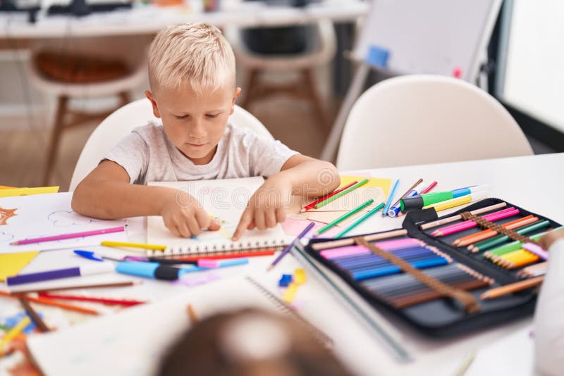 Adorable Toddler Student Drawing on Notebook Sitting on Table at ...