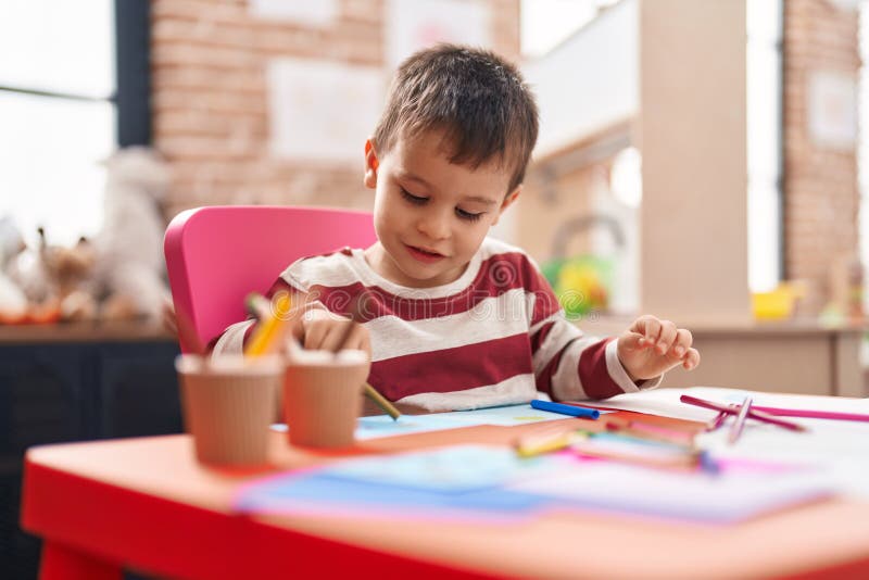 Adorable Toddler Student Drawing on Notebook Sitting on Table at ...