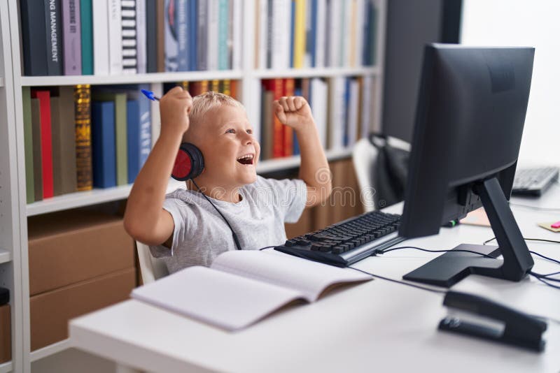 Adorable Toddler Student Using Computer with Winner Expression at ...